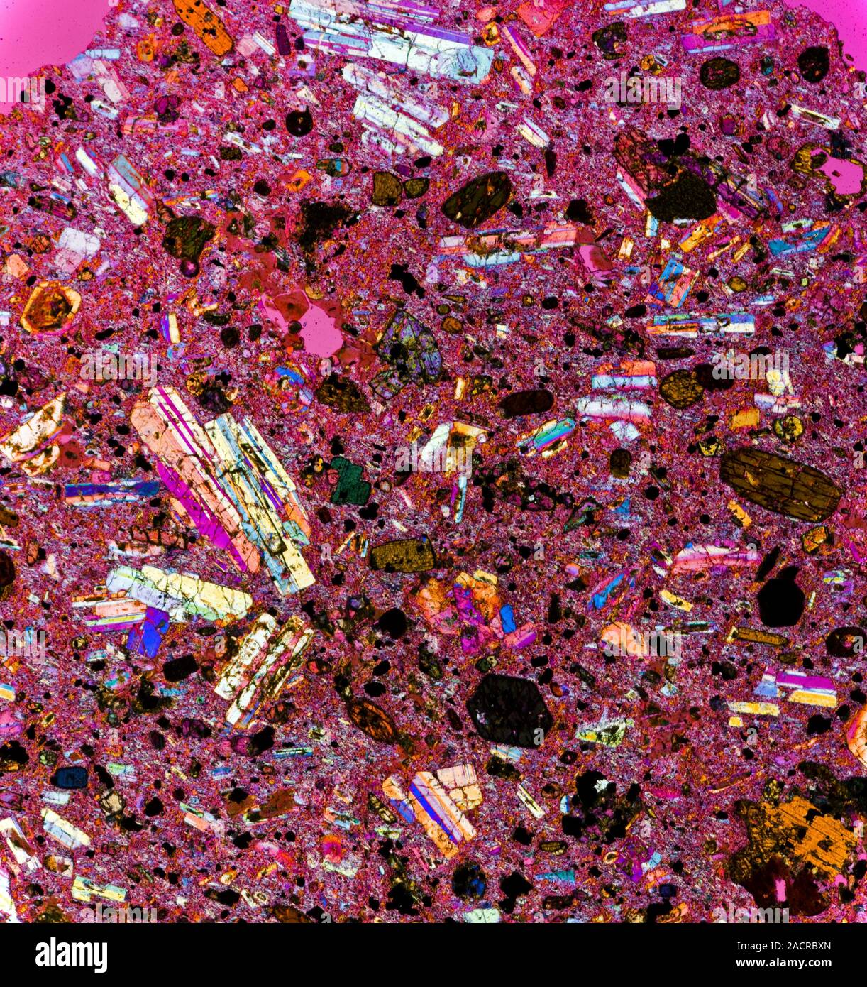 Rock mineral crystals, polarised light micrograph. This thin slice from ...