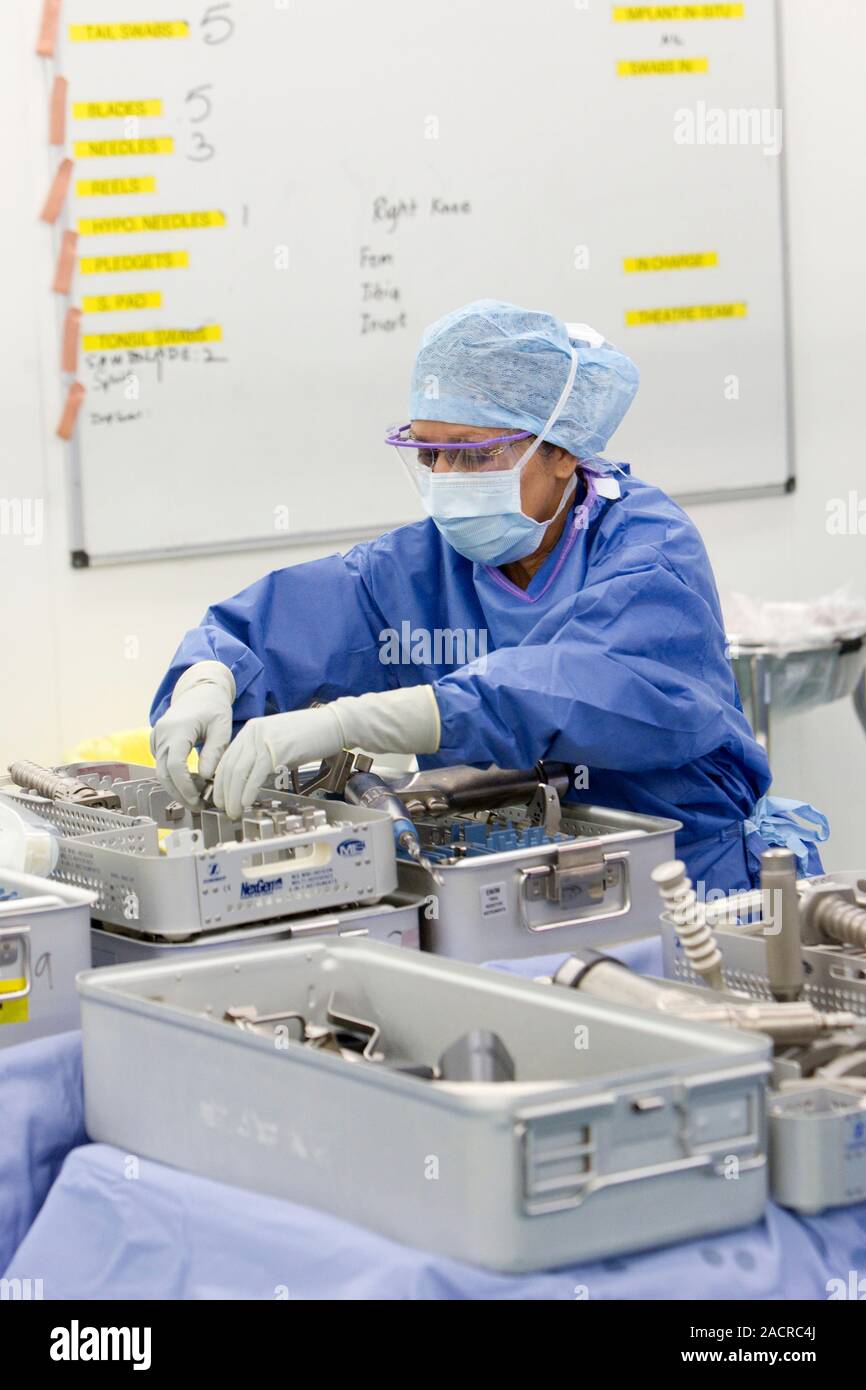 Preparing for surgery. Surgical nurse preparing instruments and ...