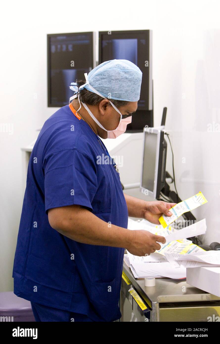Surgeon checking paperwork Stock Photo - Alamy
