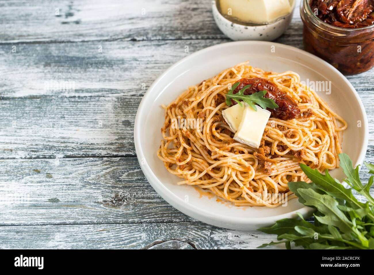 Italian Pasta with sun-dried tomato pesto and brie cheese Stock Photo ...