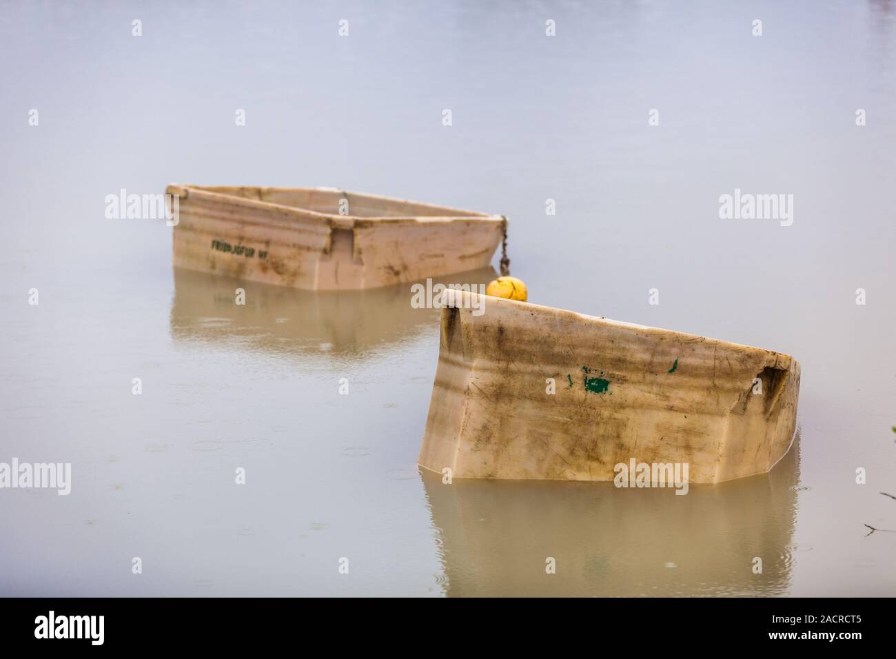 white plastic boxes floating in the water Stock Photo - Alamy