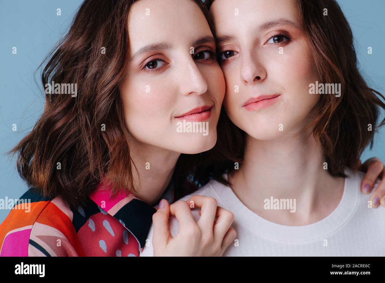 Family relationships, portrait of two twin sisters Stock Photo - Alamy