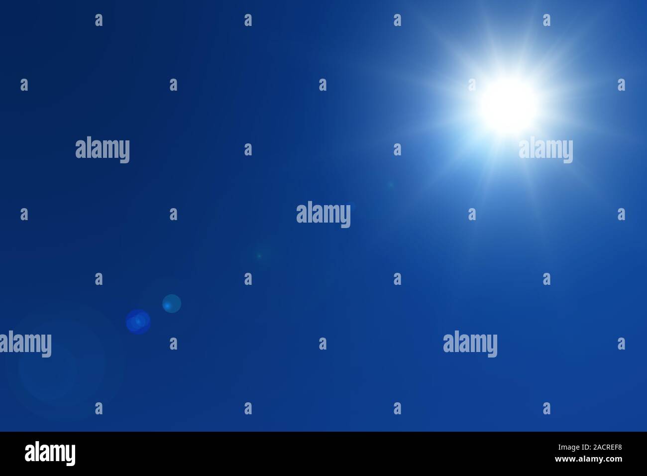 Sun with glare spots on blue sky Stock Photo - Alamy