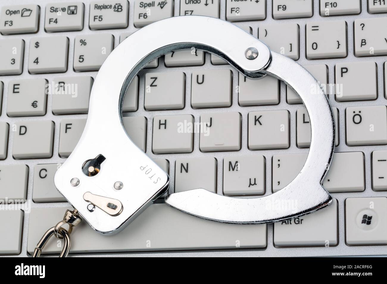 Handcuffs on Computer Keyboard Stock Photo - Alamy