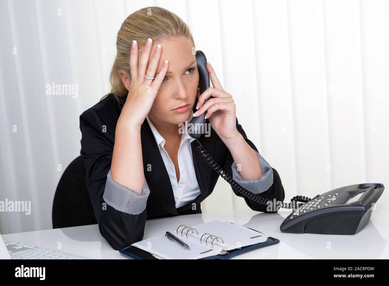 Woman with telephone in stress Stock Photo - Alamy