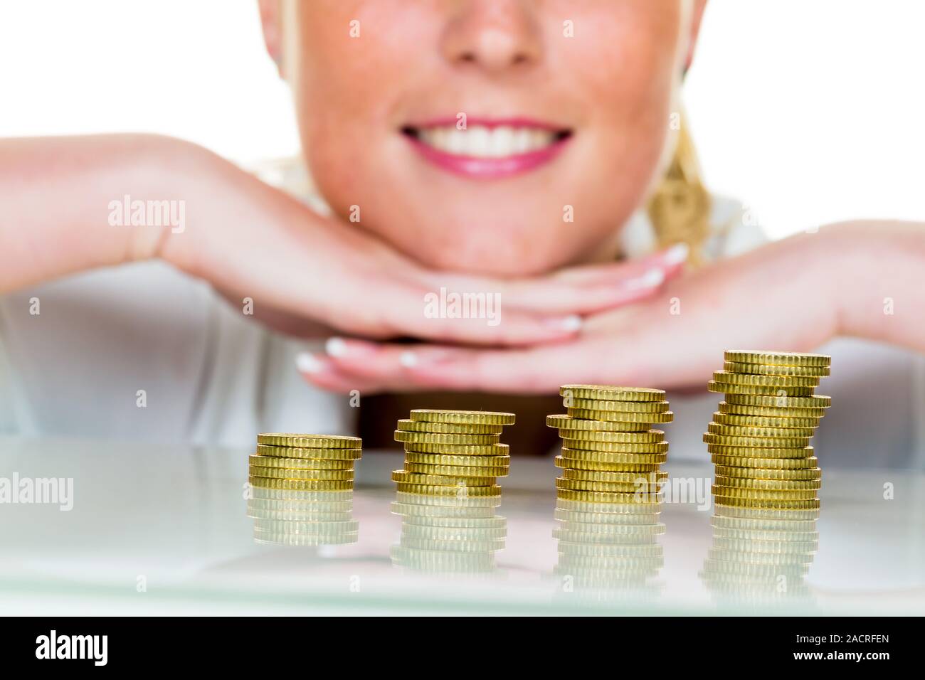 Woman stacks coins Stock Photo - Alamy