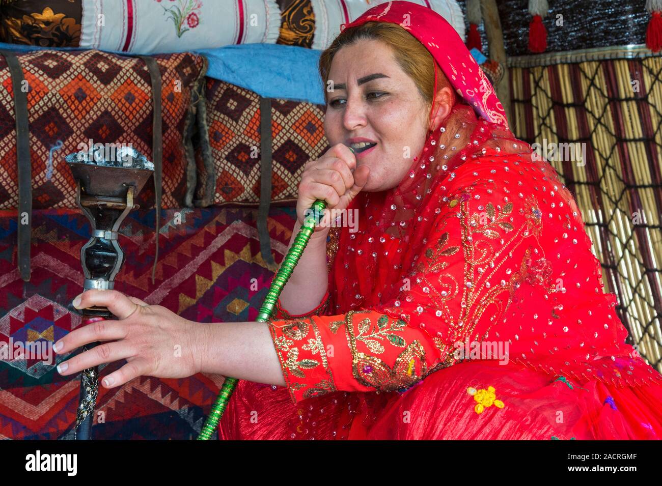 Qashqai woman smoking a water pipe in a tent, Qashqai nomad camp, Fars ...