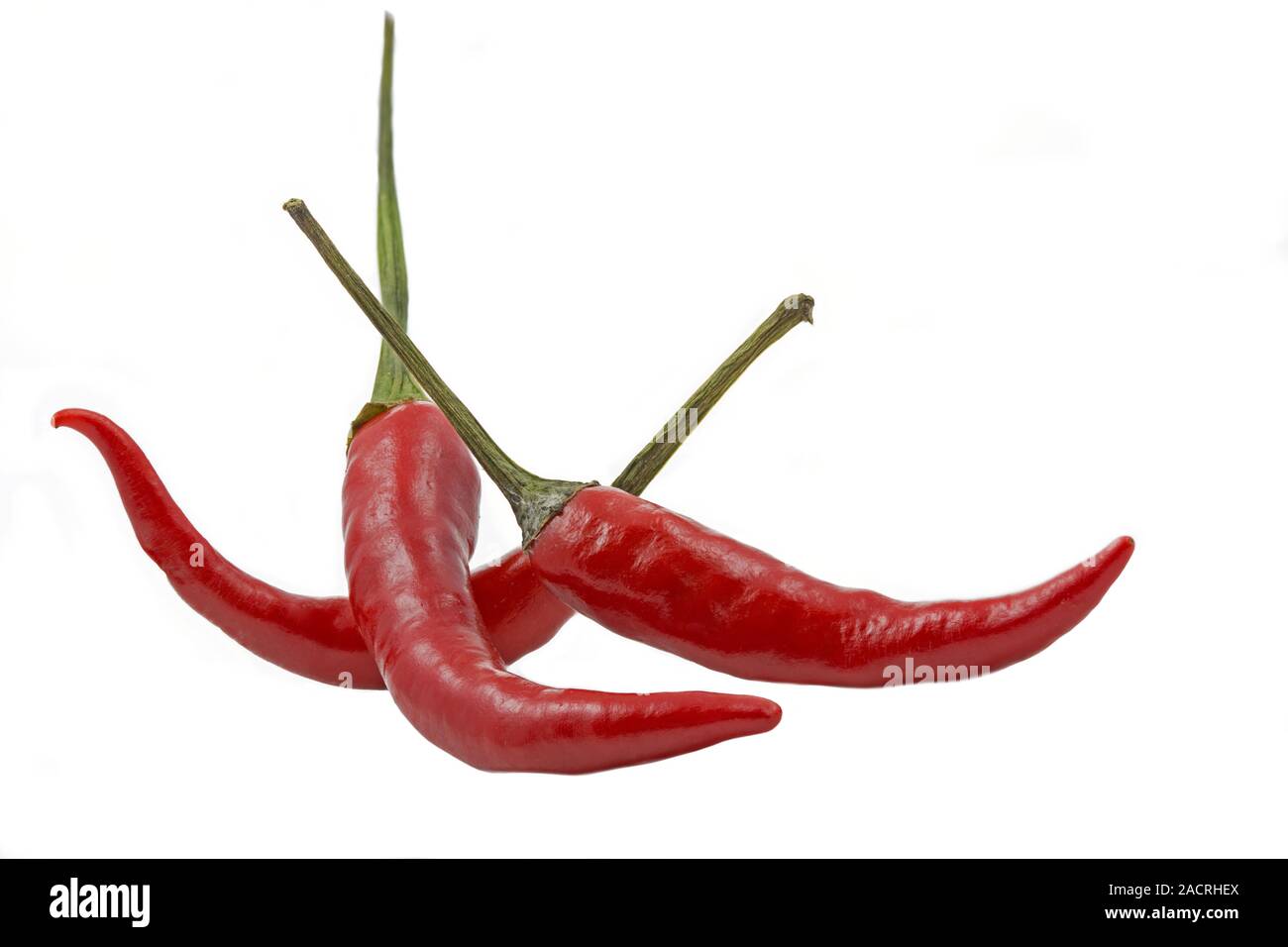 Three red chilli peppers on white background Stock Photo - Alamy
