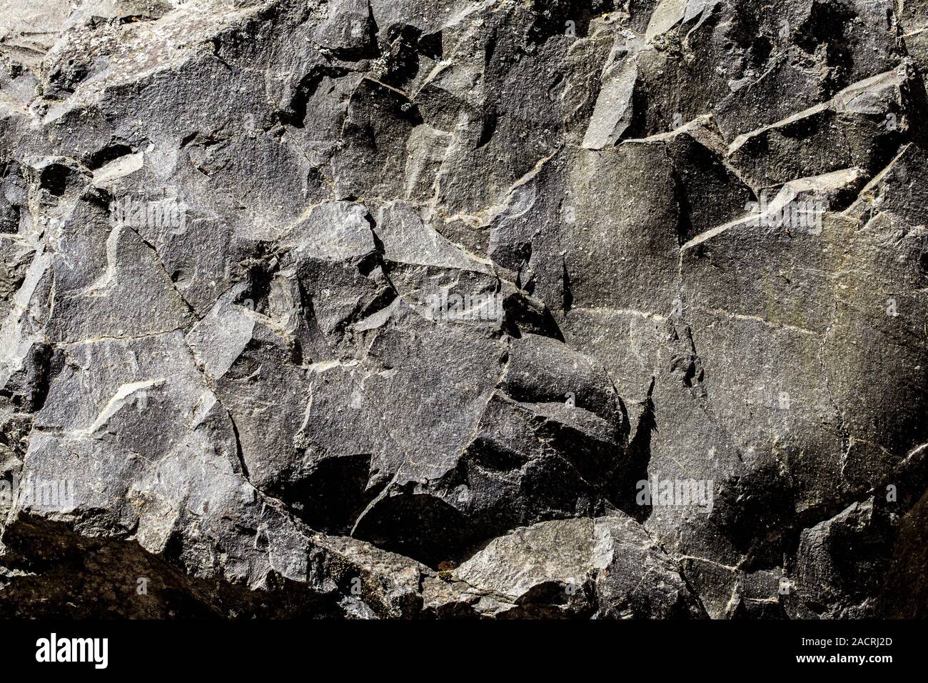 Basalt, close-up. This black volcanic rock has formed from the ...