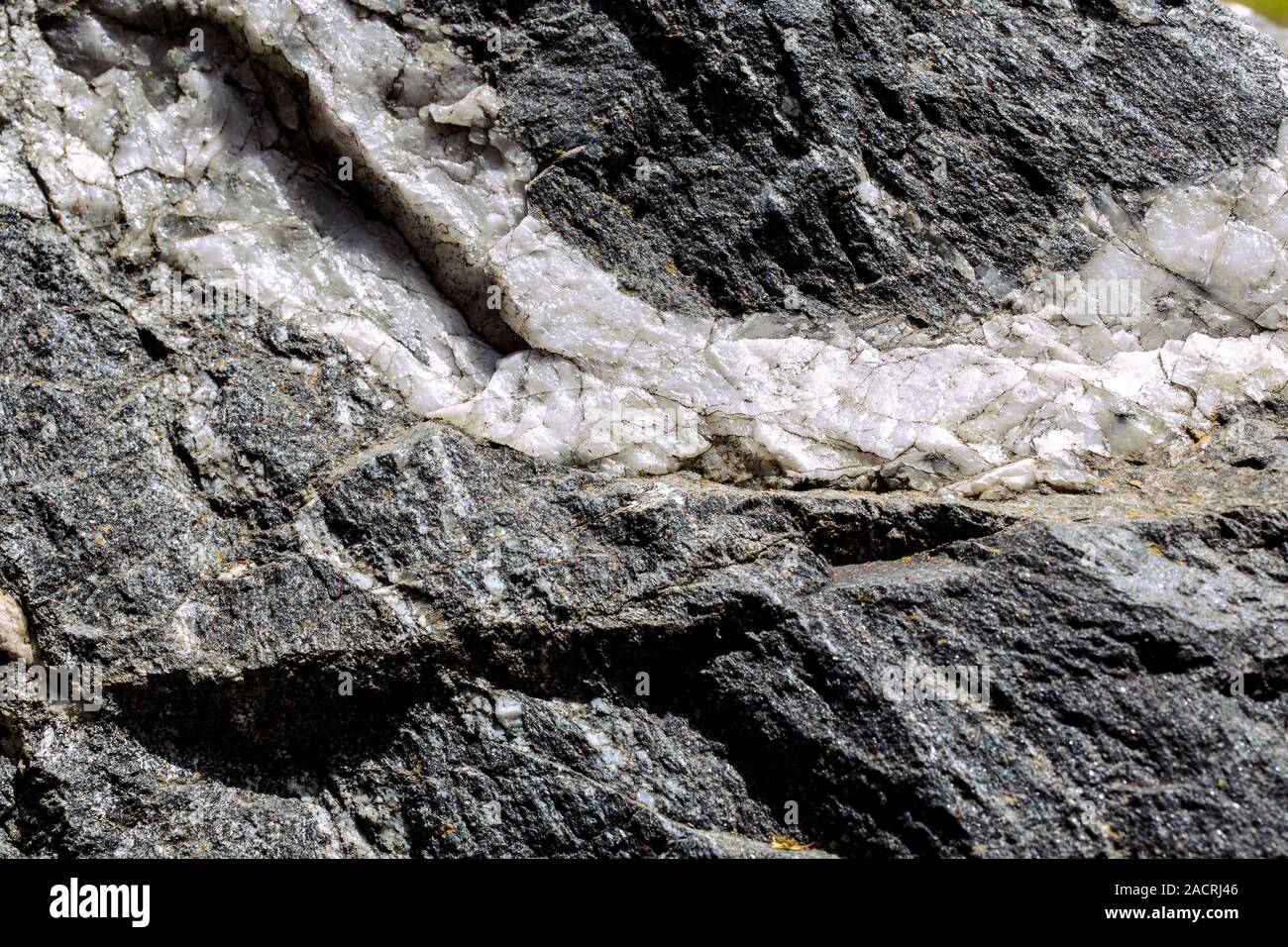 Quartz seam in schist, close-up. Seams of quartz form in fissures or ...