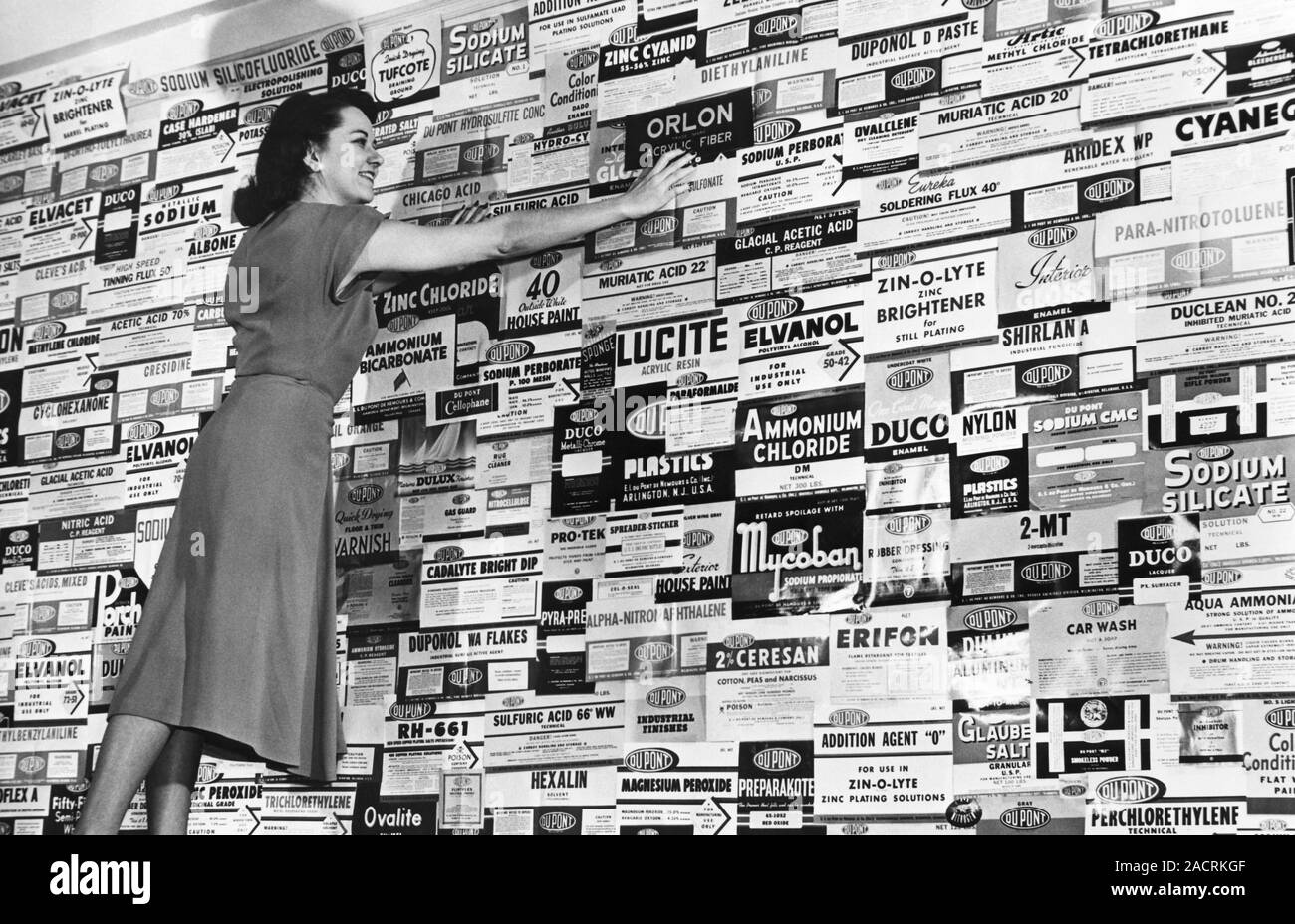 DuPont labels display. Woman adjusting a display of product labels used ...