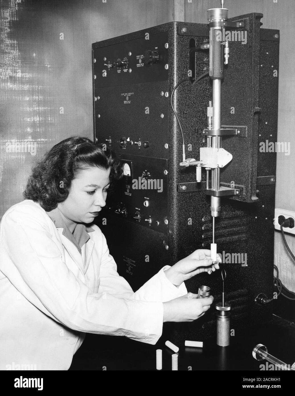 Teflon research. Laboratory technician testing a piece of Teflon ...