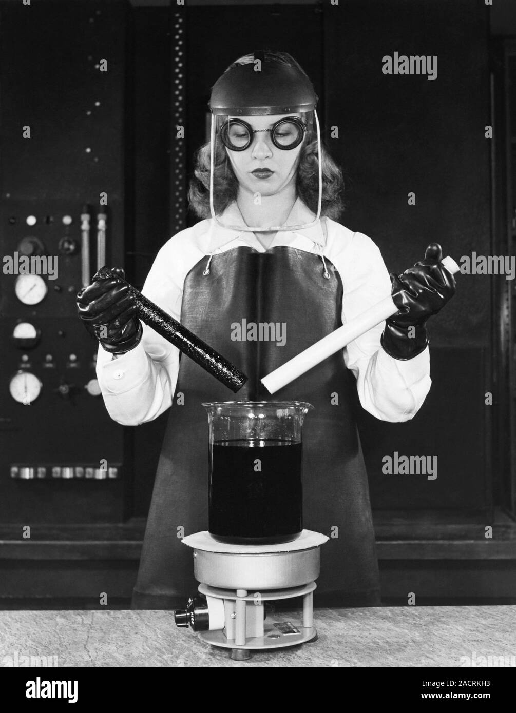 Teflon research. Laboratory technician carrying out a test to compare ...