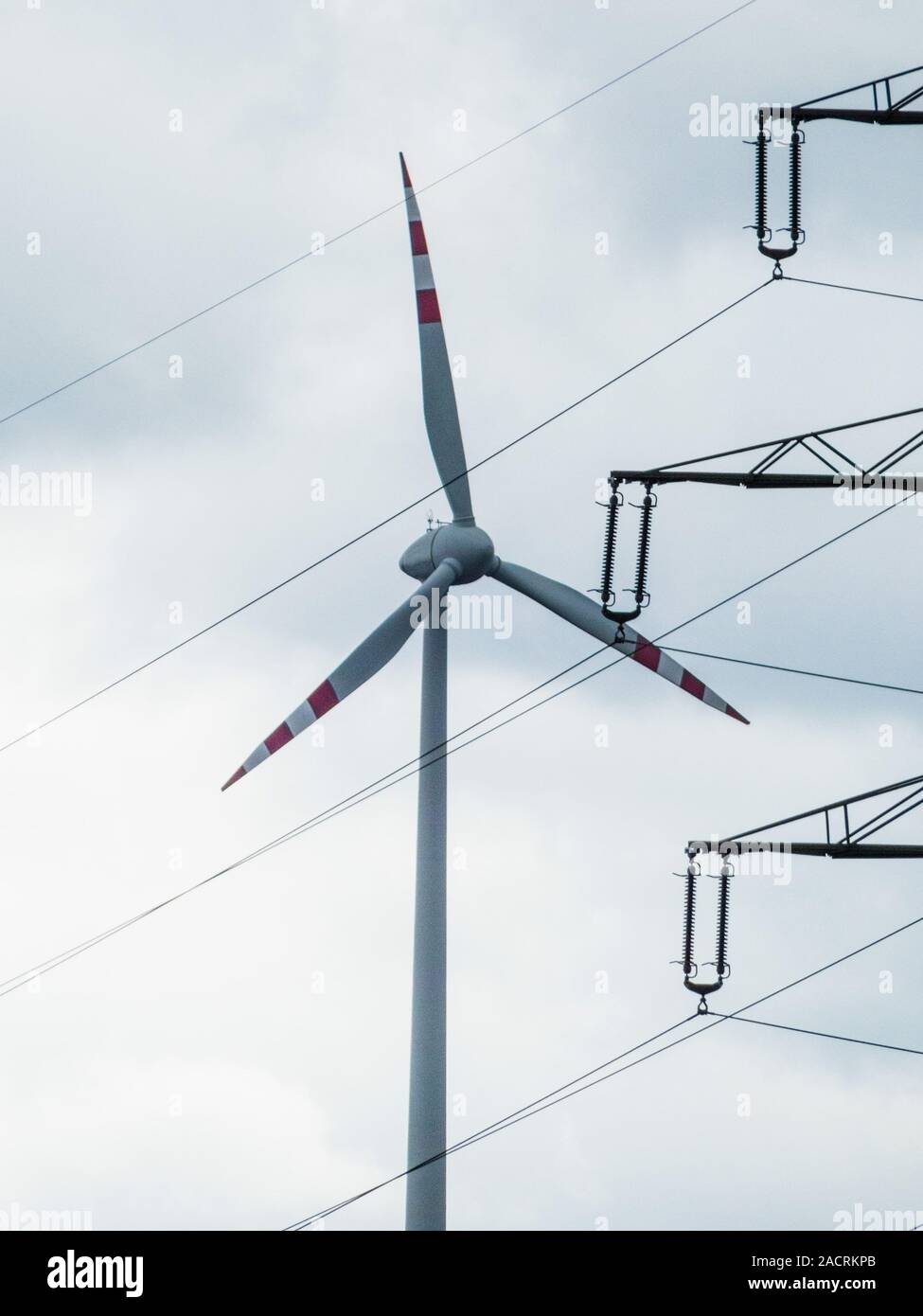 Wind turbine and power pylons Stock Photo - Alamy