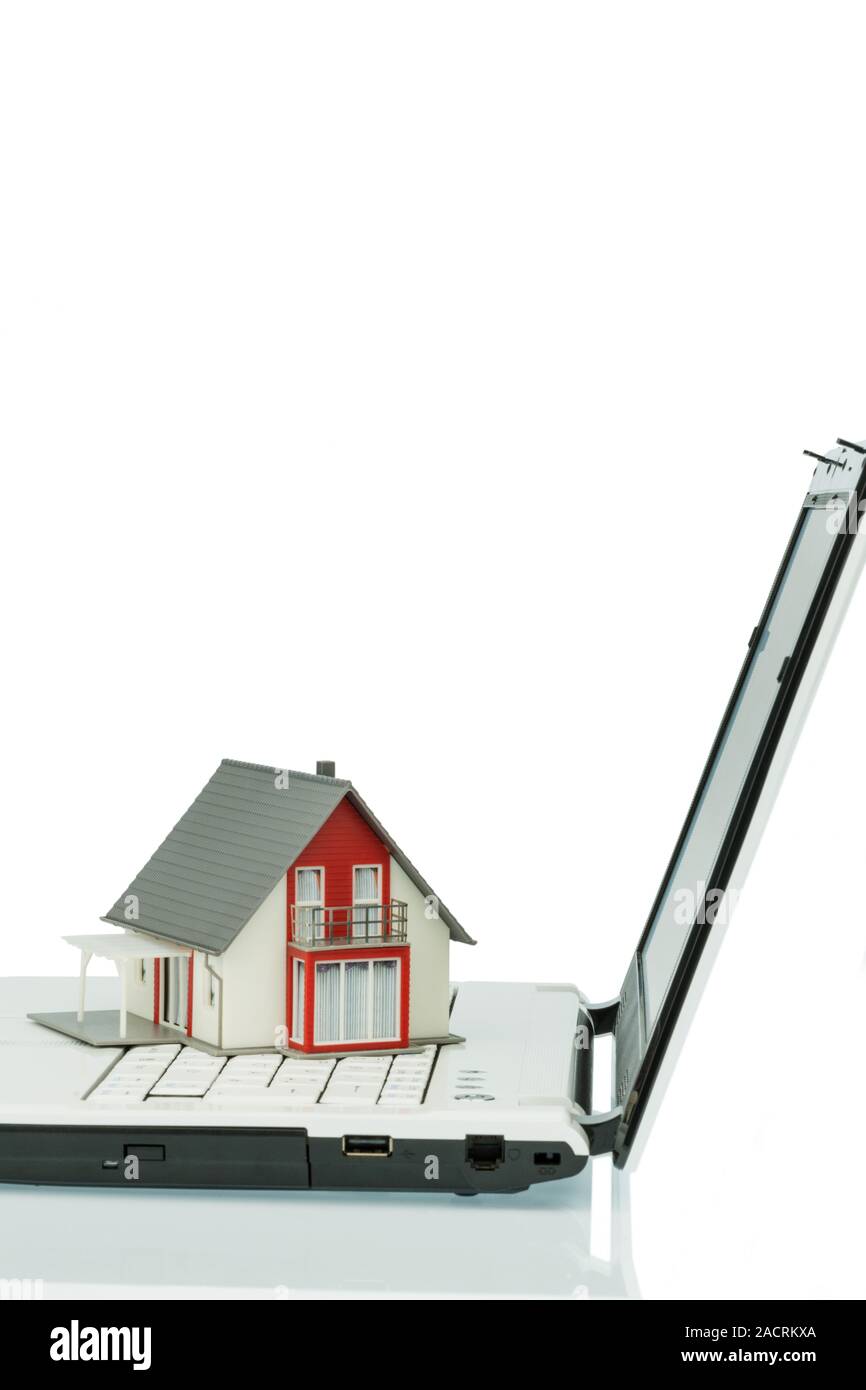 Residential house on computer keyboard Stock Photo - Alamy