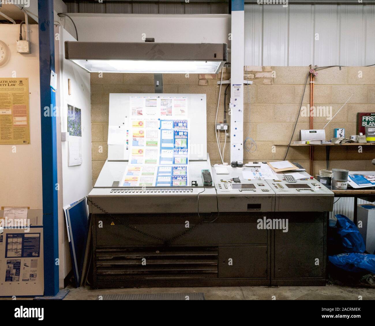 Offset printer controls, with samples of printed materials. This ...