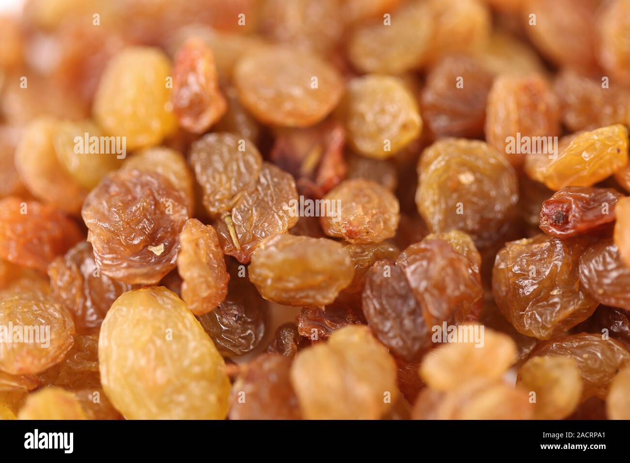 Golden raisins background Stock Photo - Alamy