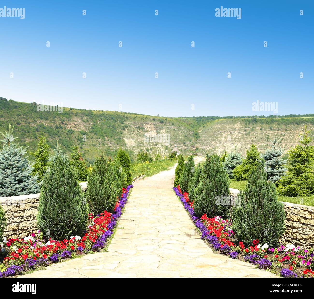 Nice stone walkway from garden in the far Stock Photo - Alamy