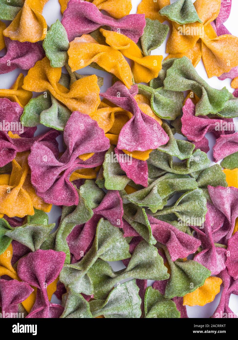 Fresh Fresh Italian Pasta background. Raw Bow tie colourful pasta close ...