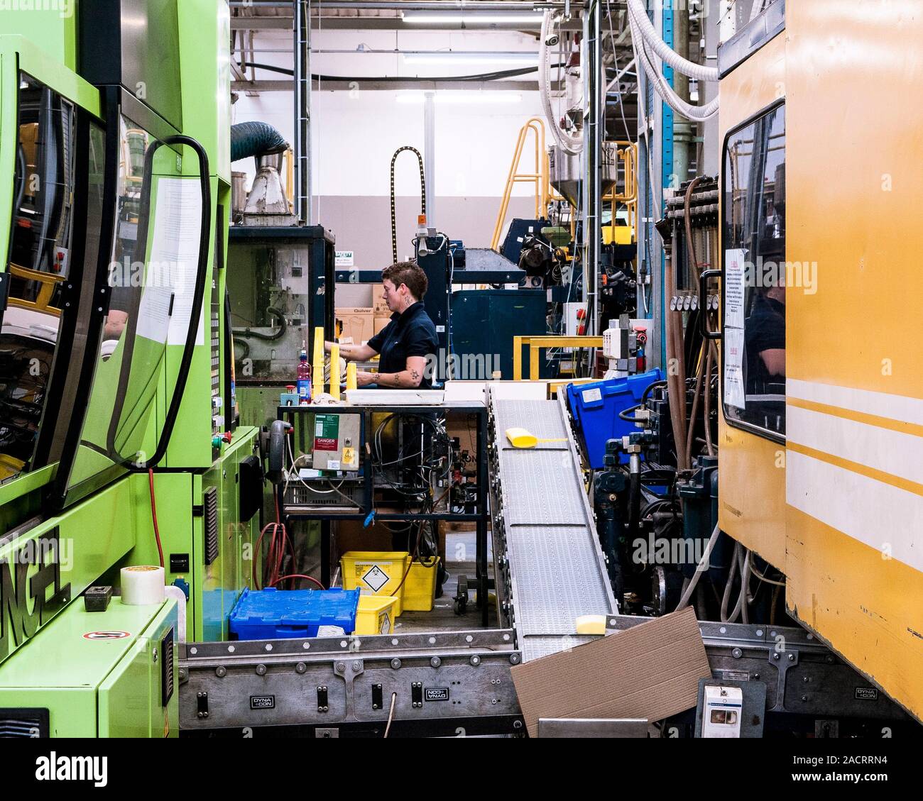 Plastics factory production line. Worker in a factory, operating ...