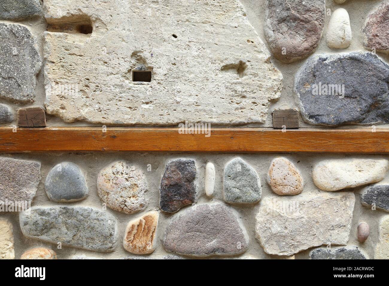 wooden board concreted into a stone wall Stock Photo - Alamy