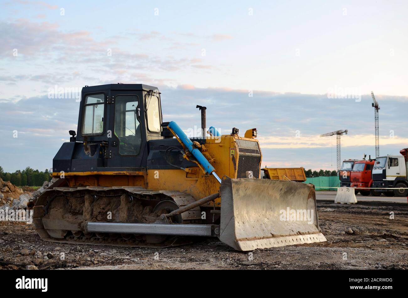 Track-type bulldozer on construction site. Land clearing, grading, pool ...