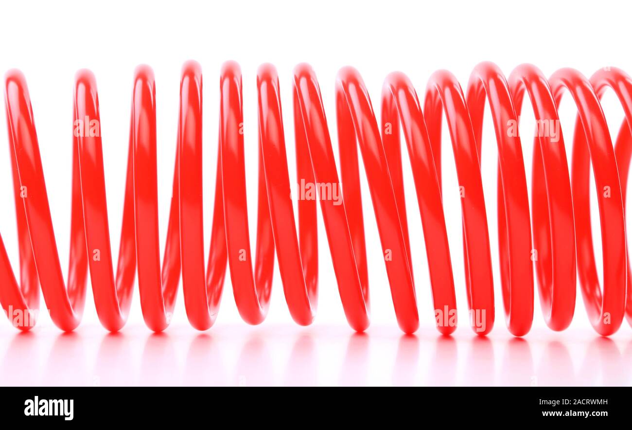 Plastic spring isolated on a white background Stock Photo - Alamy