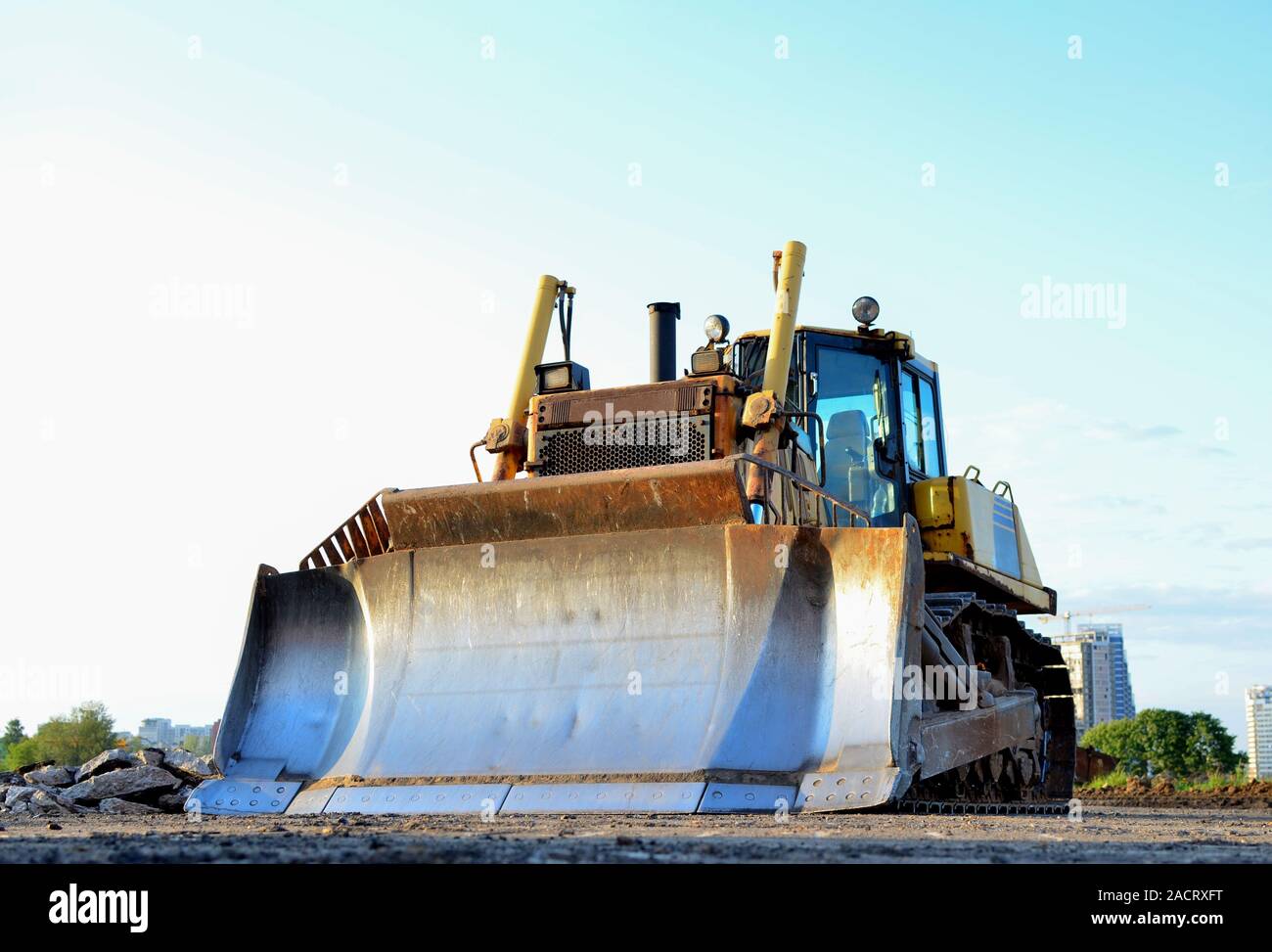 Track-type bulldozer on construction site. Land clearing, grading, pool ...