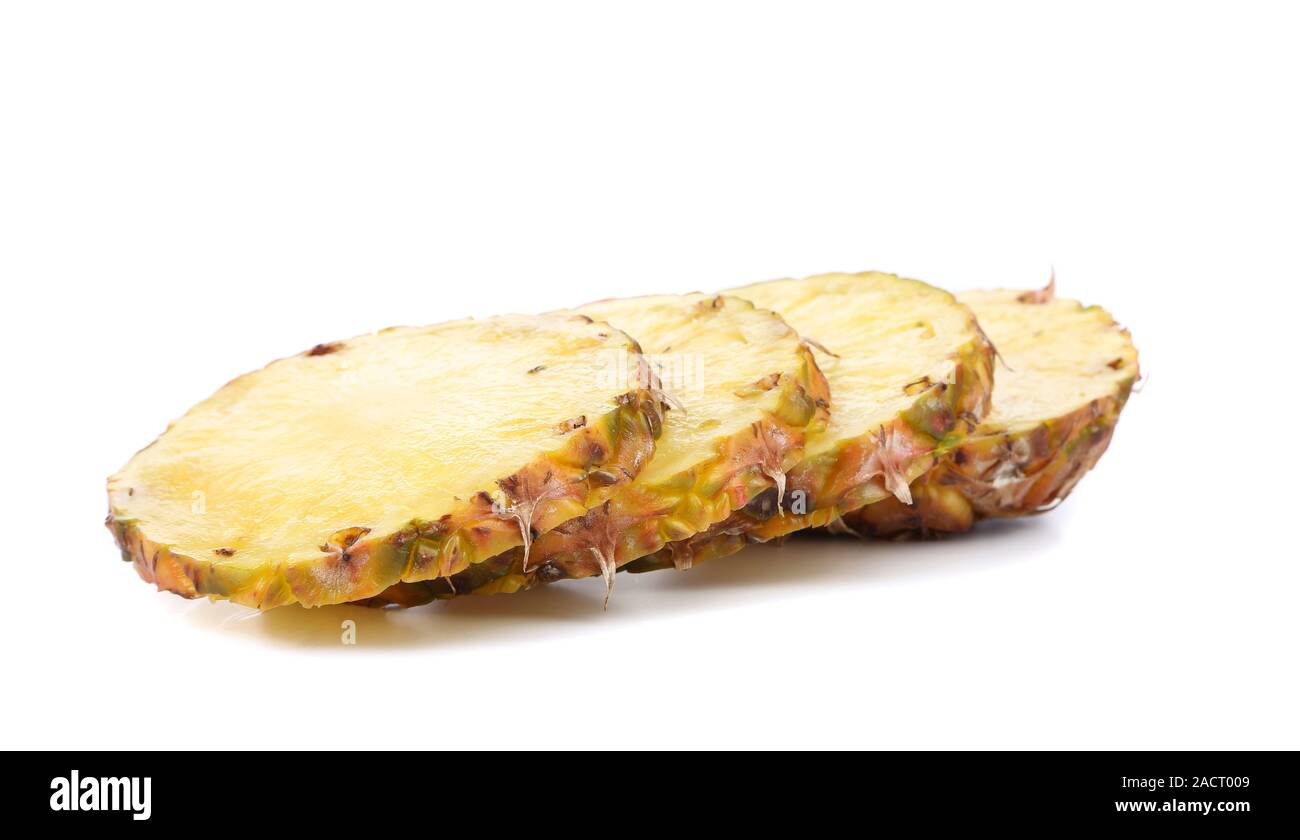 Row sliced pineapple on a white background Stock Photo - Alamy