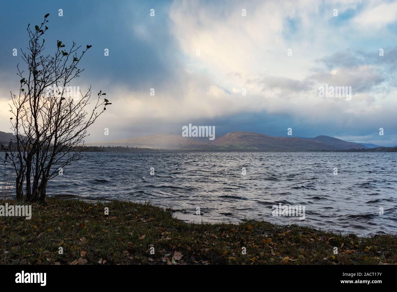 Moody skies over a choppy lake Stock Photo - Alamy