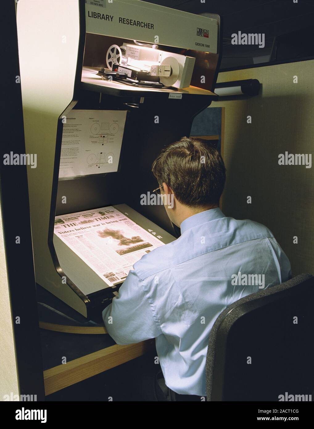 Using a microfilm reader. Image taken from Photographs of the British ...