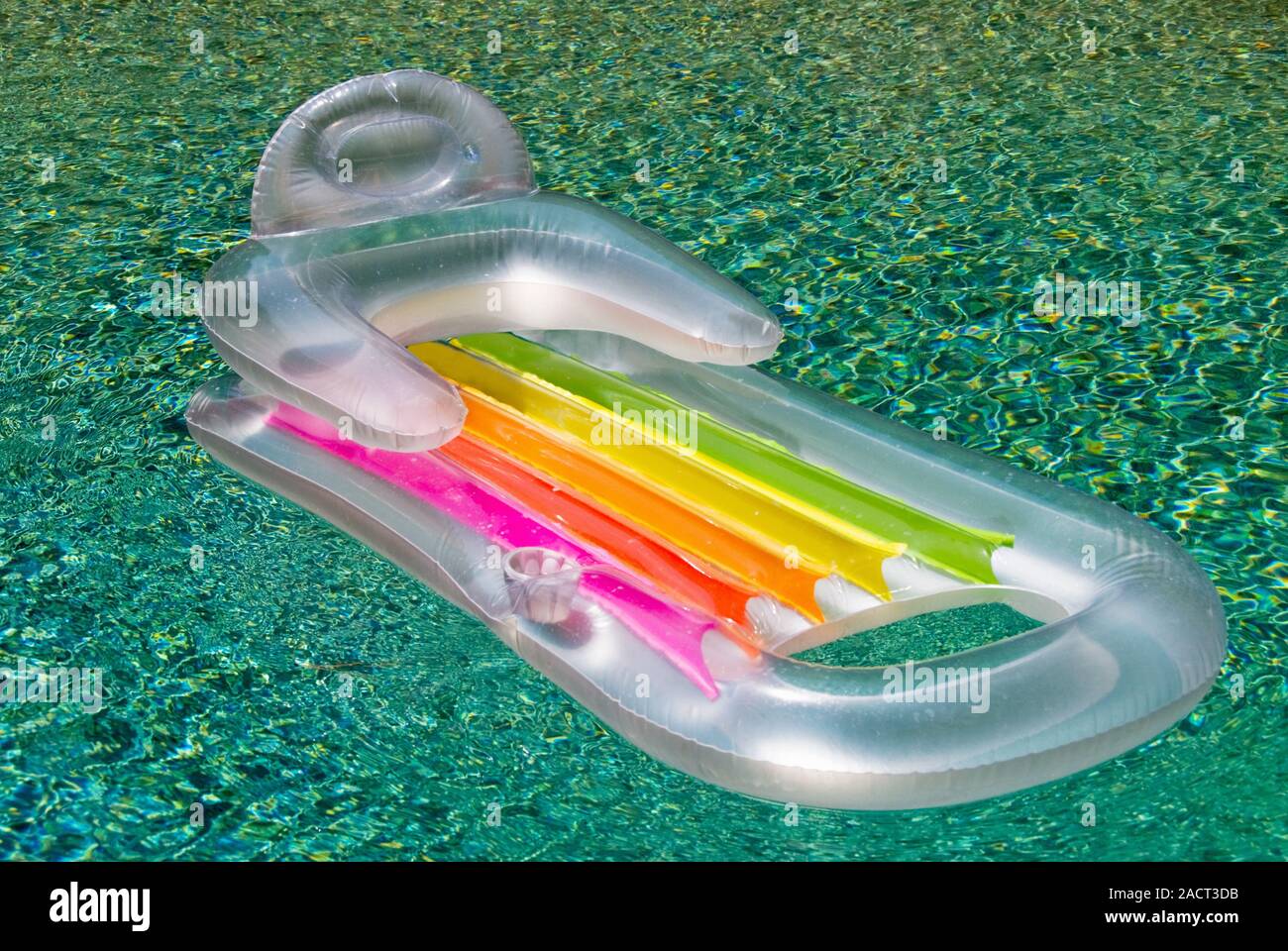 One empty inflatable plastic air raft floating in a concrete swimming ...