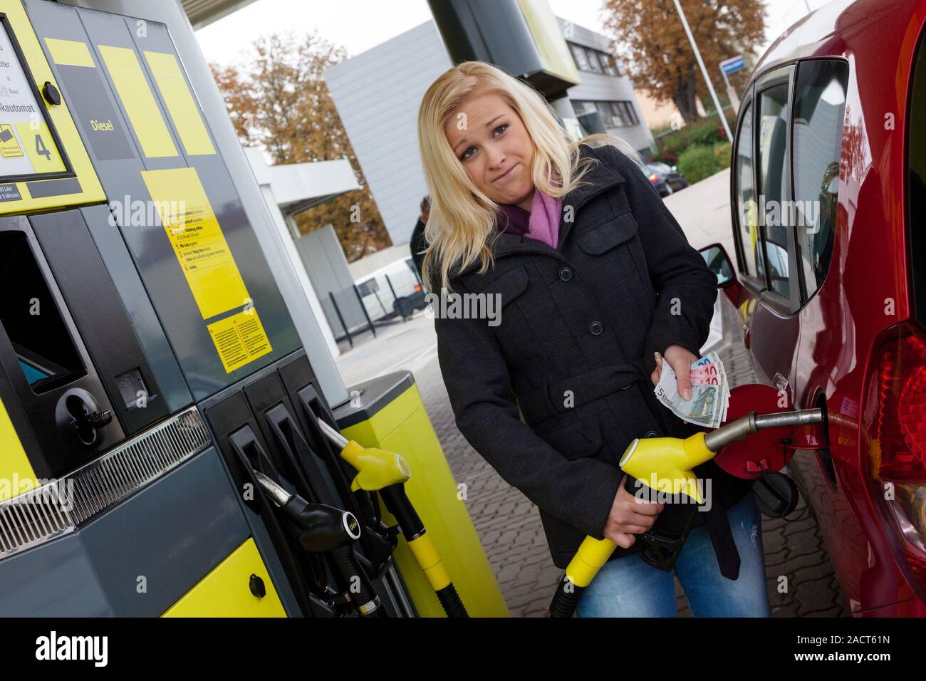 Woman refueling at a gas station Stock Photo - Alamy