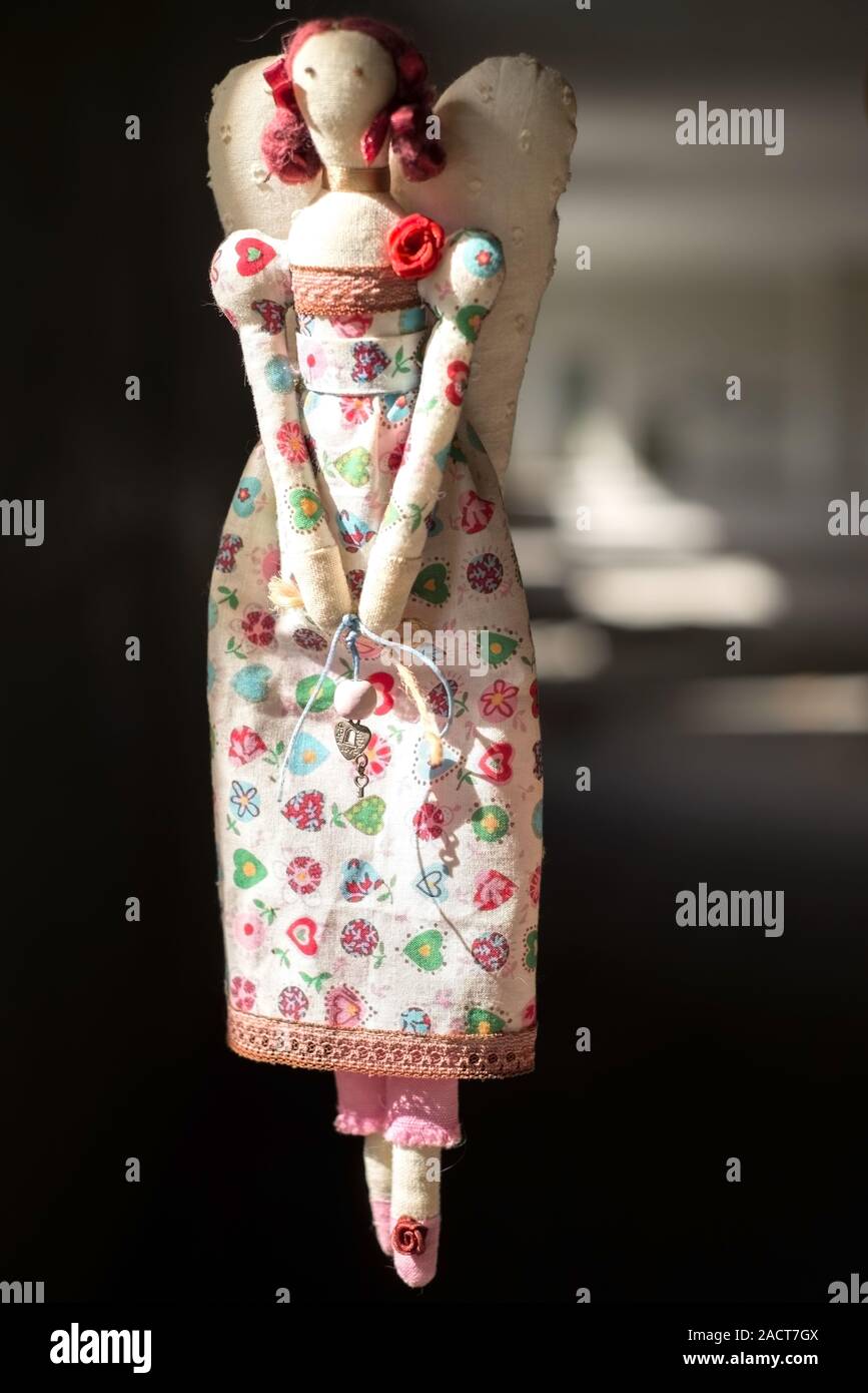 Portrait of a colorful voodoo doll. Against the background of light ...