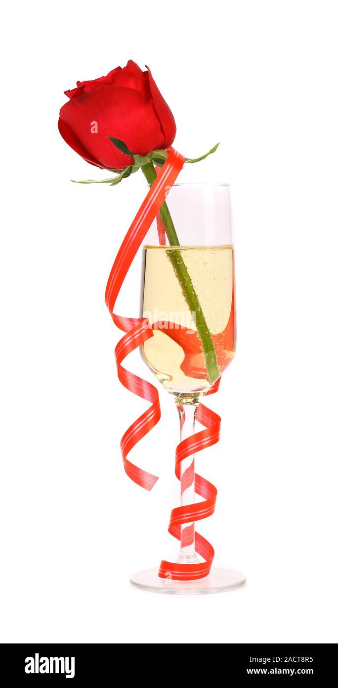 Red rose in glass of champagne and paper streamer Stock Photo - Alamy