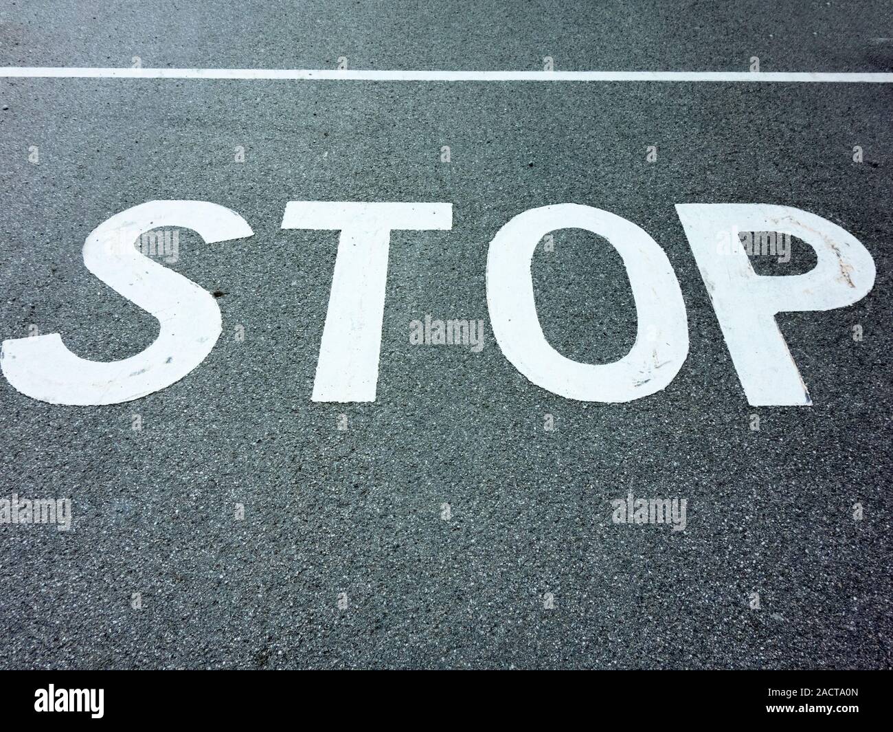 STOP inscription on a road Stock Photo - Alamy