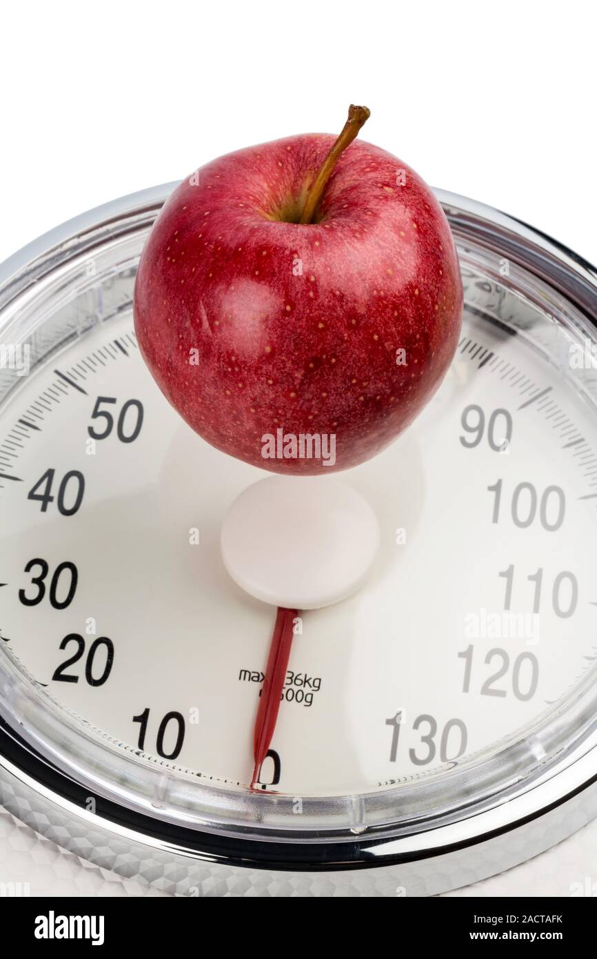 Apple lies on a scale Stock Photo - Alamy