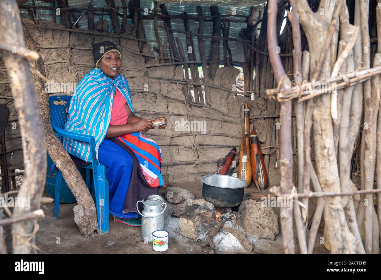 same, Tanzania, 11th June 2019: maasai woman cooking in her kitchen ...