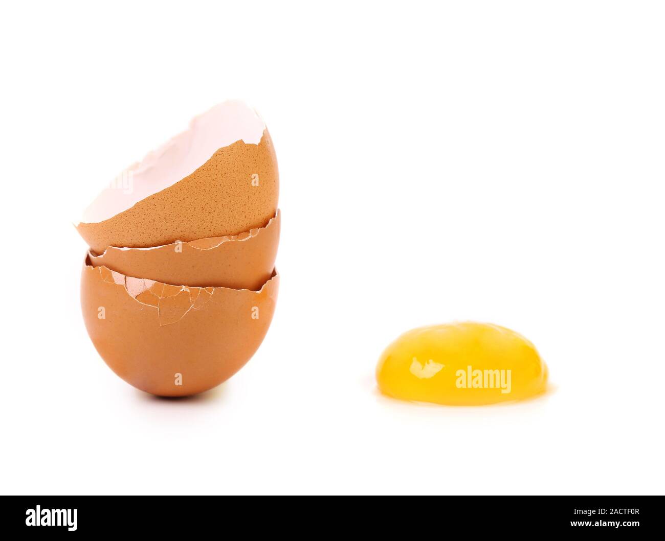 Two broken eggs and one yolk Stock Photo - Alamy