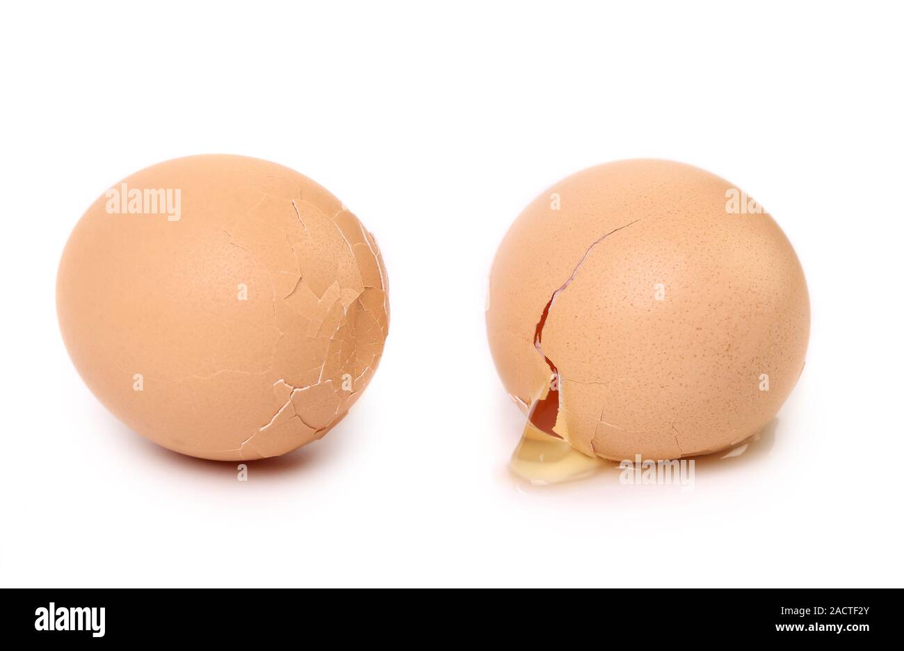 Two broken eggs isolated on white background Stock Photo - Alamy
