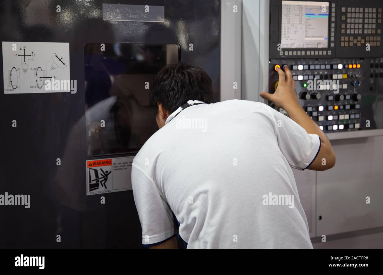 Industrial worker input data to operate cnc machine Stock Photo - Alamy Industrial worker input data to operate cnc machine Stock Photo - Alamy