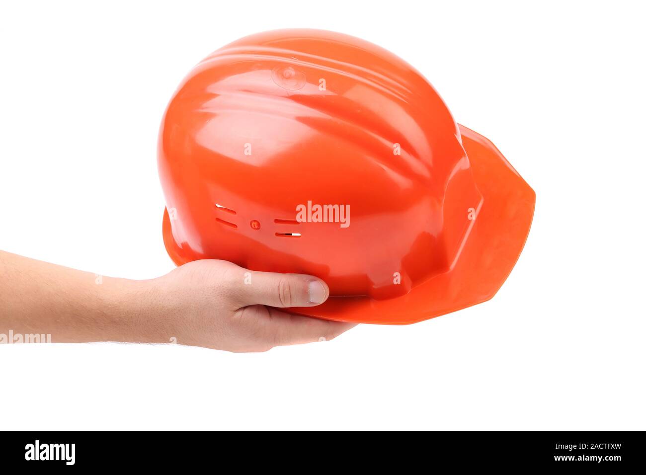 Hand holding orange hard hat Stock Photo - Alamy