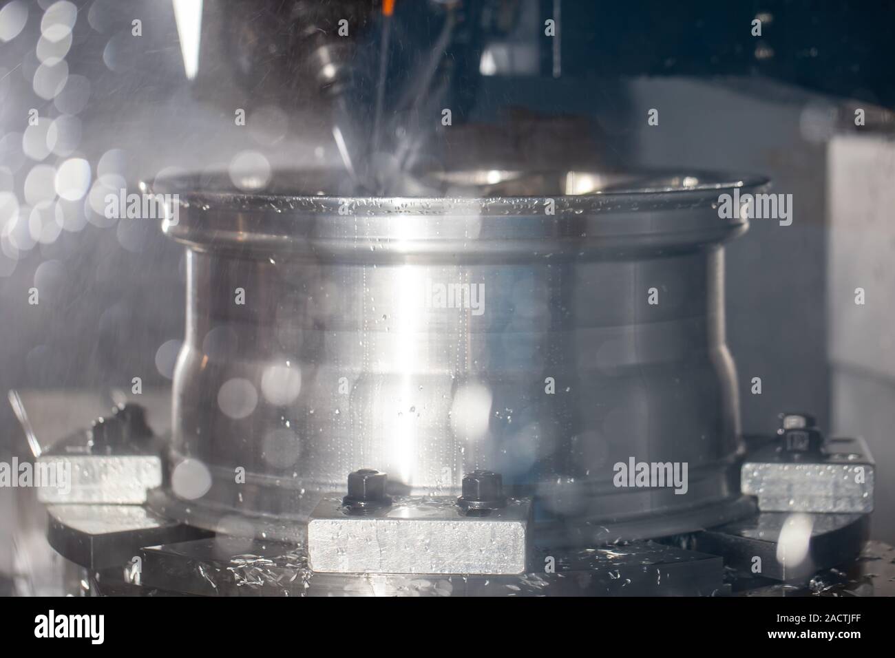 Modern CNC machine machining car alloy wheel with coolant Stock Photo ...