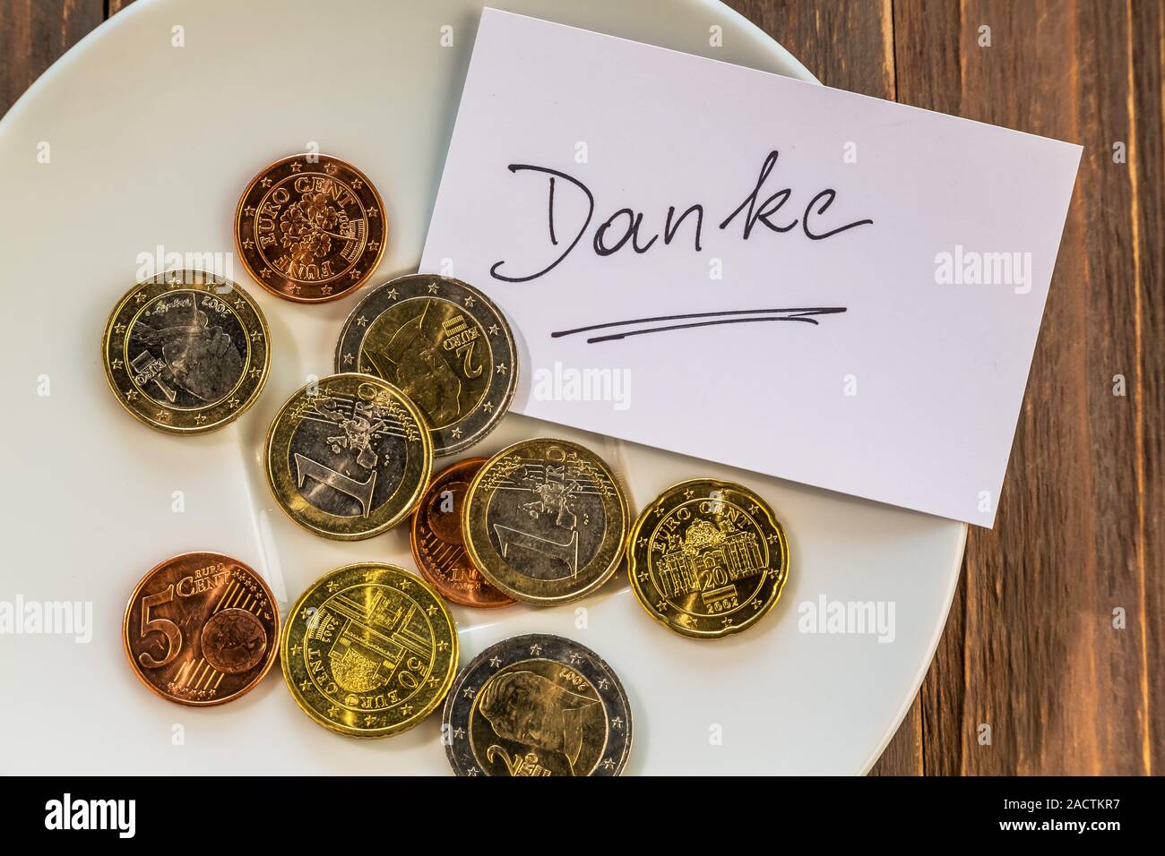 Plate with coins Stock Photo - Alamy
