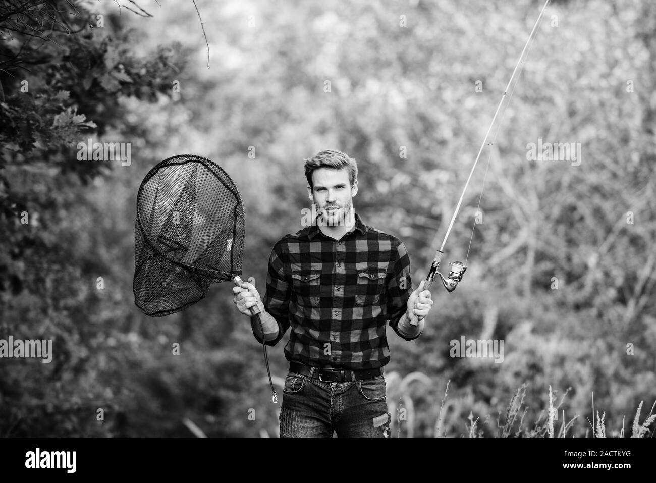 Summer weekend concept. Fishing day. Handsome guy in checkered shirt ...