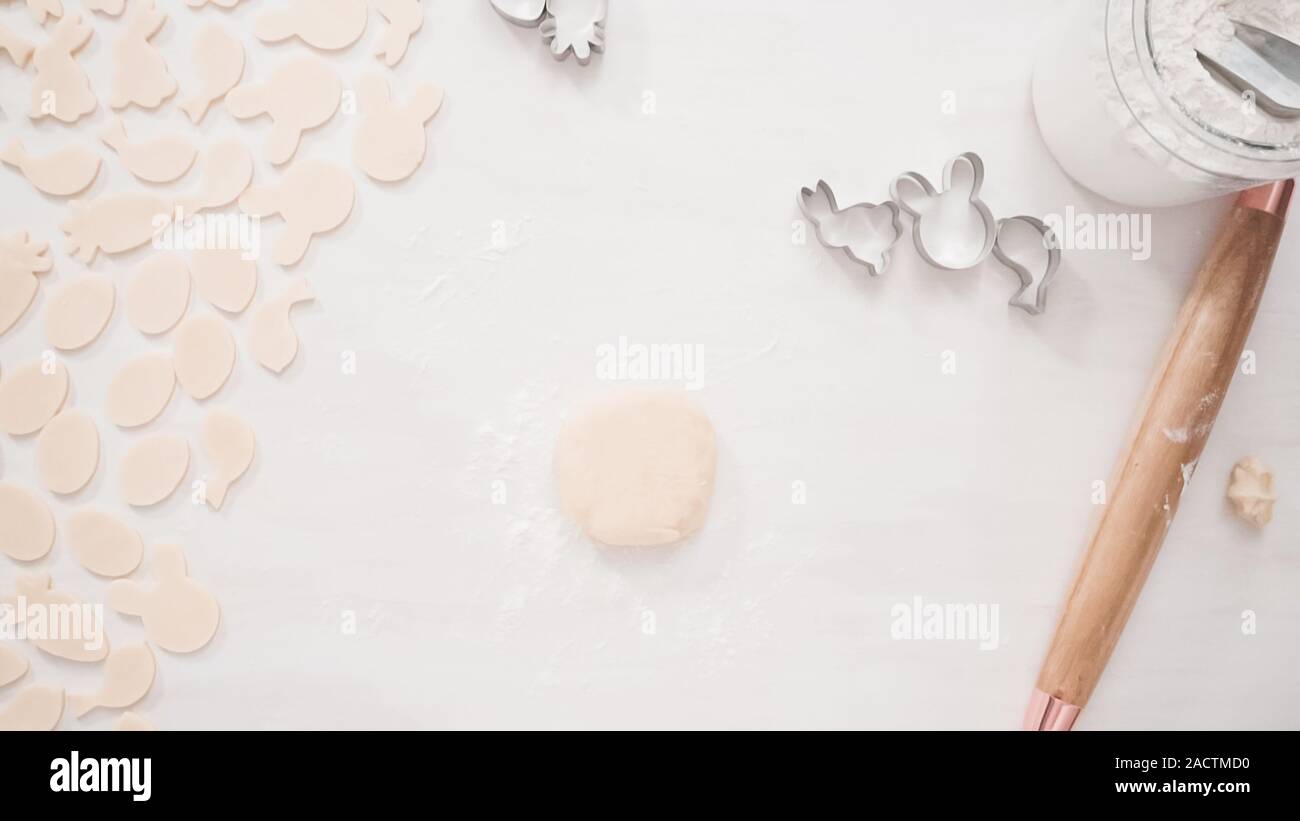Step by step. Flat lay. Cutting sugar cookie dough with Easter shaped ...