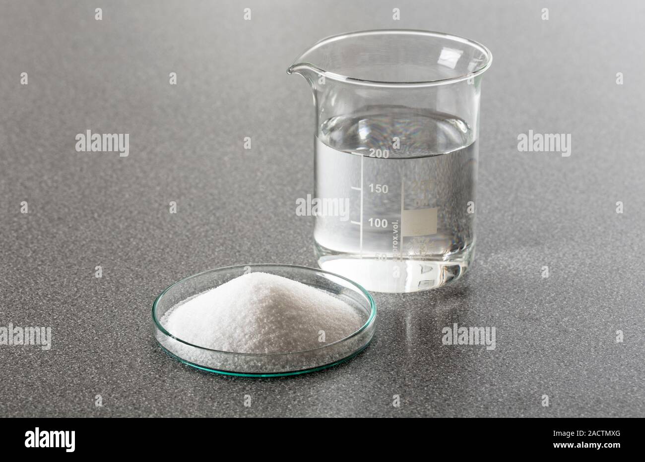 Mole of sodium chloride with a beaker of water. Contained in the petri ...