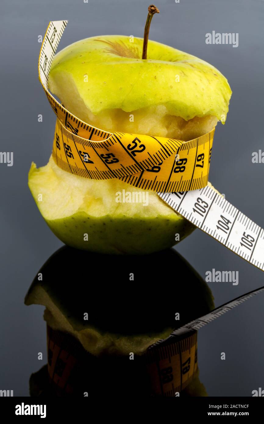 Apple on with tape measure Stock Photo - Alamy
