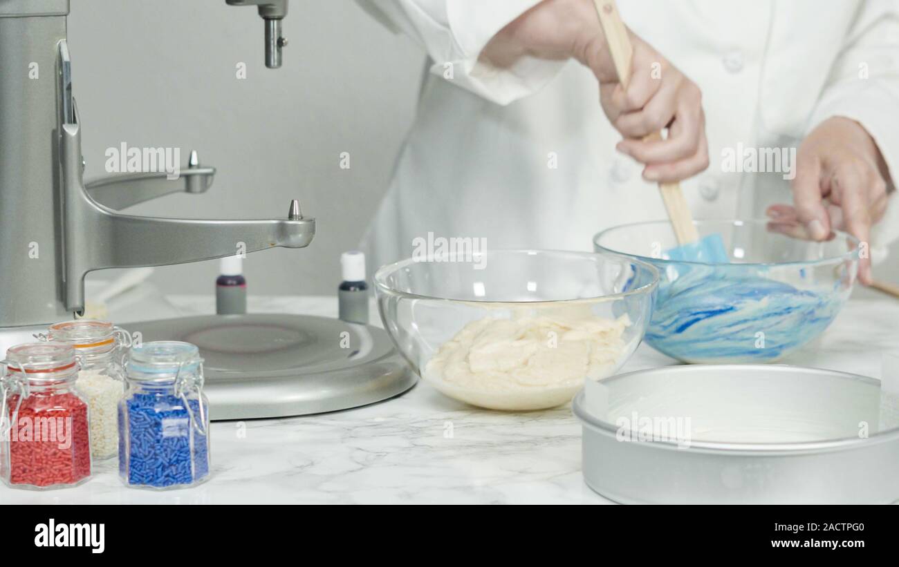 Step by step. Mixing food coloring into a cake batter to bake a three ...