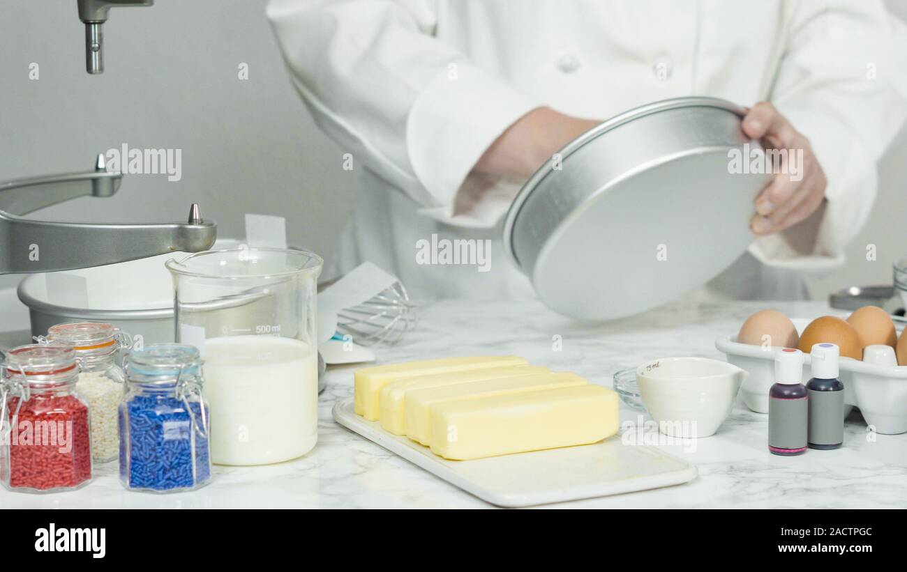 Step by step. Greasing cake pans with butter to bake a three-layer ...